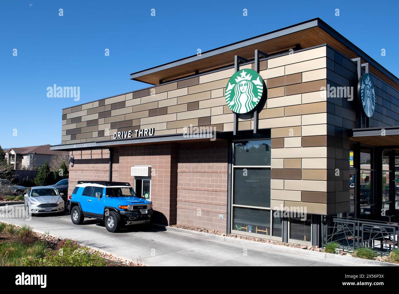 Exteriors of modern Starbucks coffee locations with drive thru windows ...