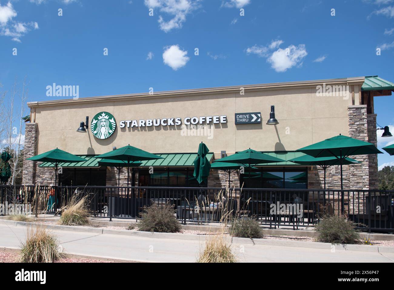 Exteriors of modern Starbucks coffee locations with drive thru windows ...