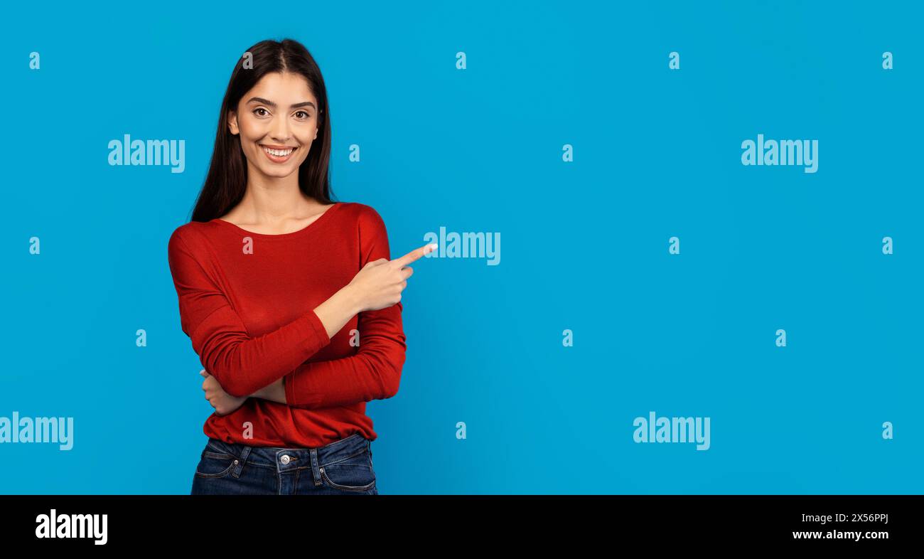 Woman in Red Shirt Pointing at Something, Empty Space Stock Photo - Alamy