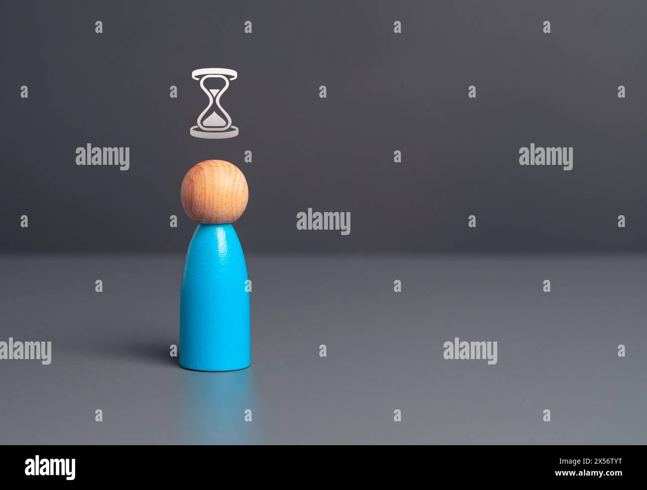 A figurine of a man waiting. Hourglass above your head. Waiting time ...