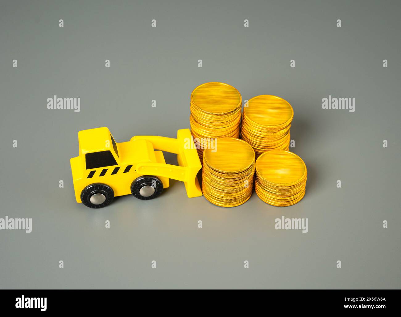 Accumulation of money and savings. A forklift pushes money coins into a ... Accumulation of money and savings. A forklift pushes money coins into a ...