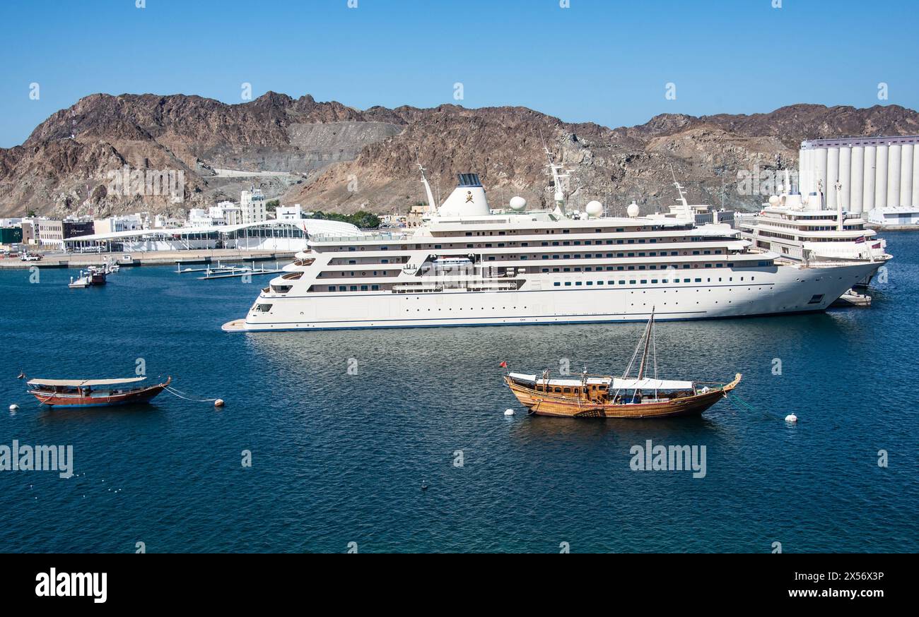 Cruise ship and traditional dhows in the Mutrah Harbor, Muscat, Oman ...