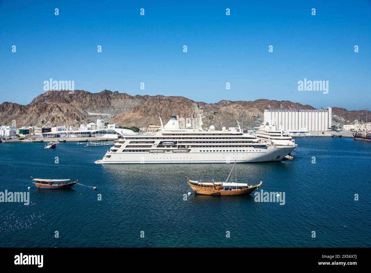 Cruise ship and traditional dhows in the Mutrah Harbor, Muscat, Oman ...