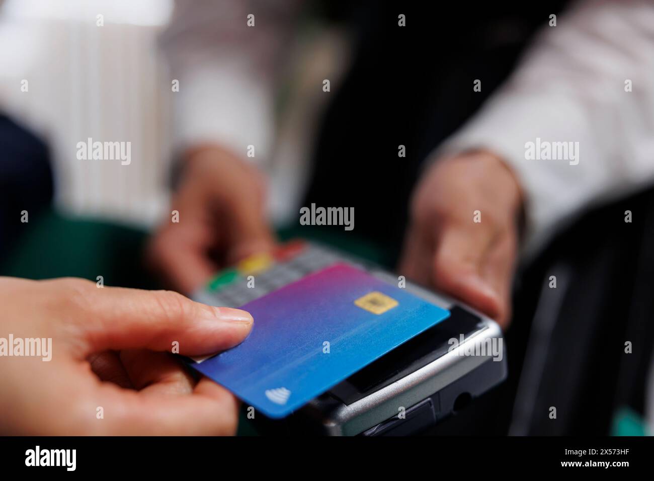 Detailed view showing hands of hotel employee holding pos terminal ...