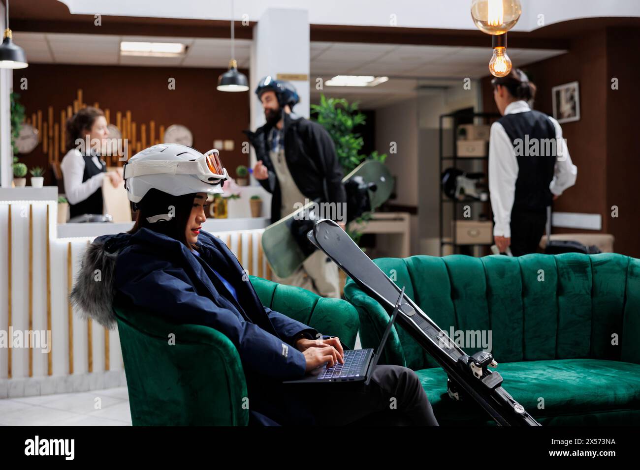 Couch in lounge area provides comfort for asian woman in snow gear as ...