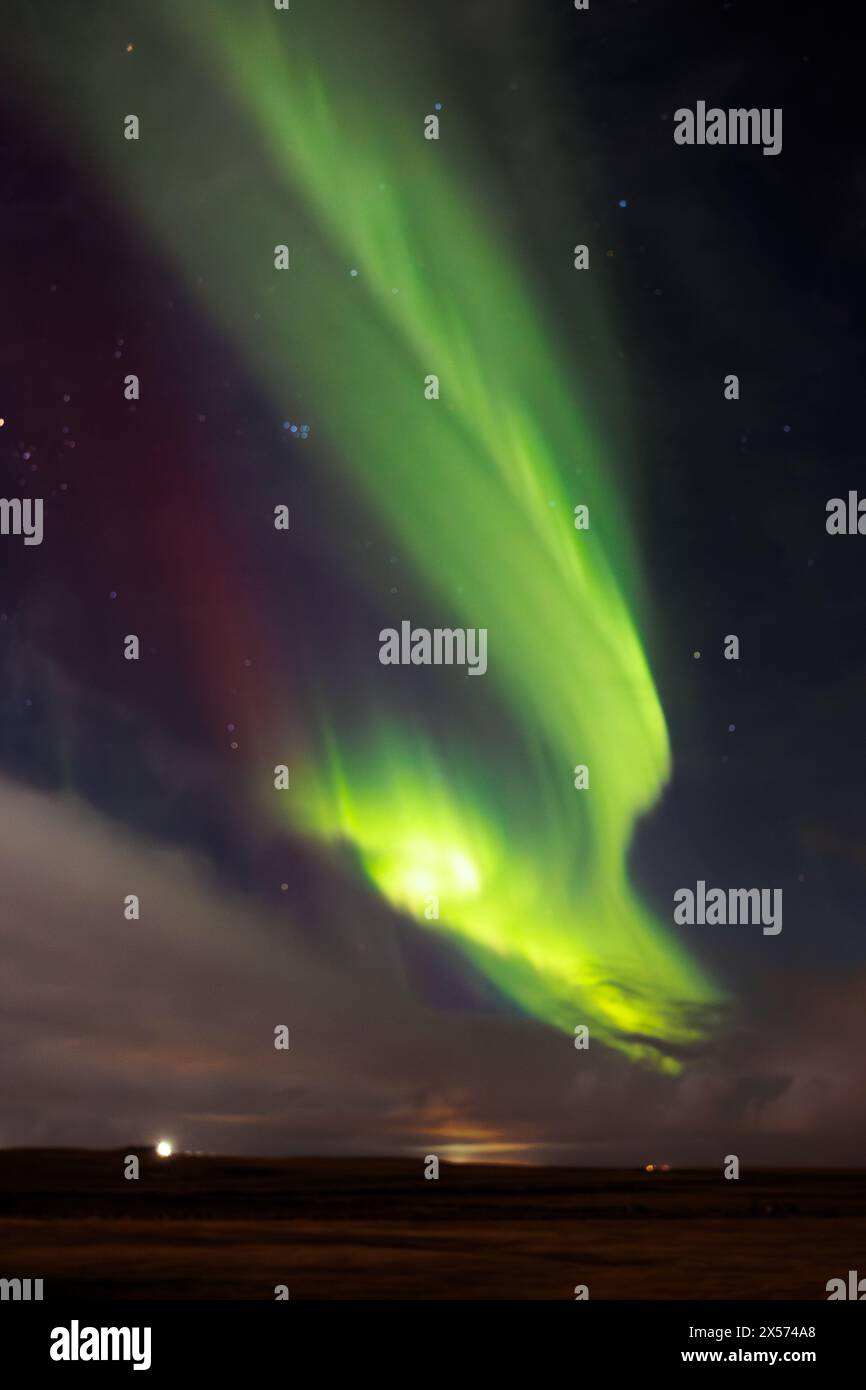 Aurora borealis over icelandic scenery, snowy mountains and glowing ...