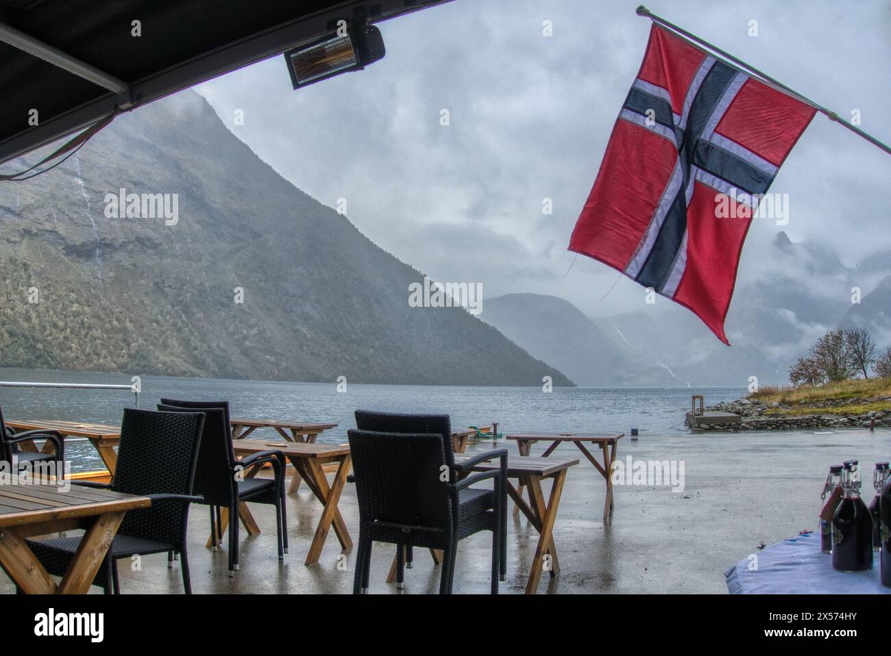 A cozy cafe bar in Norway, nestled between fog-covered mountains by a ...