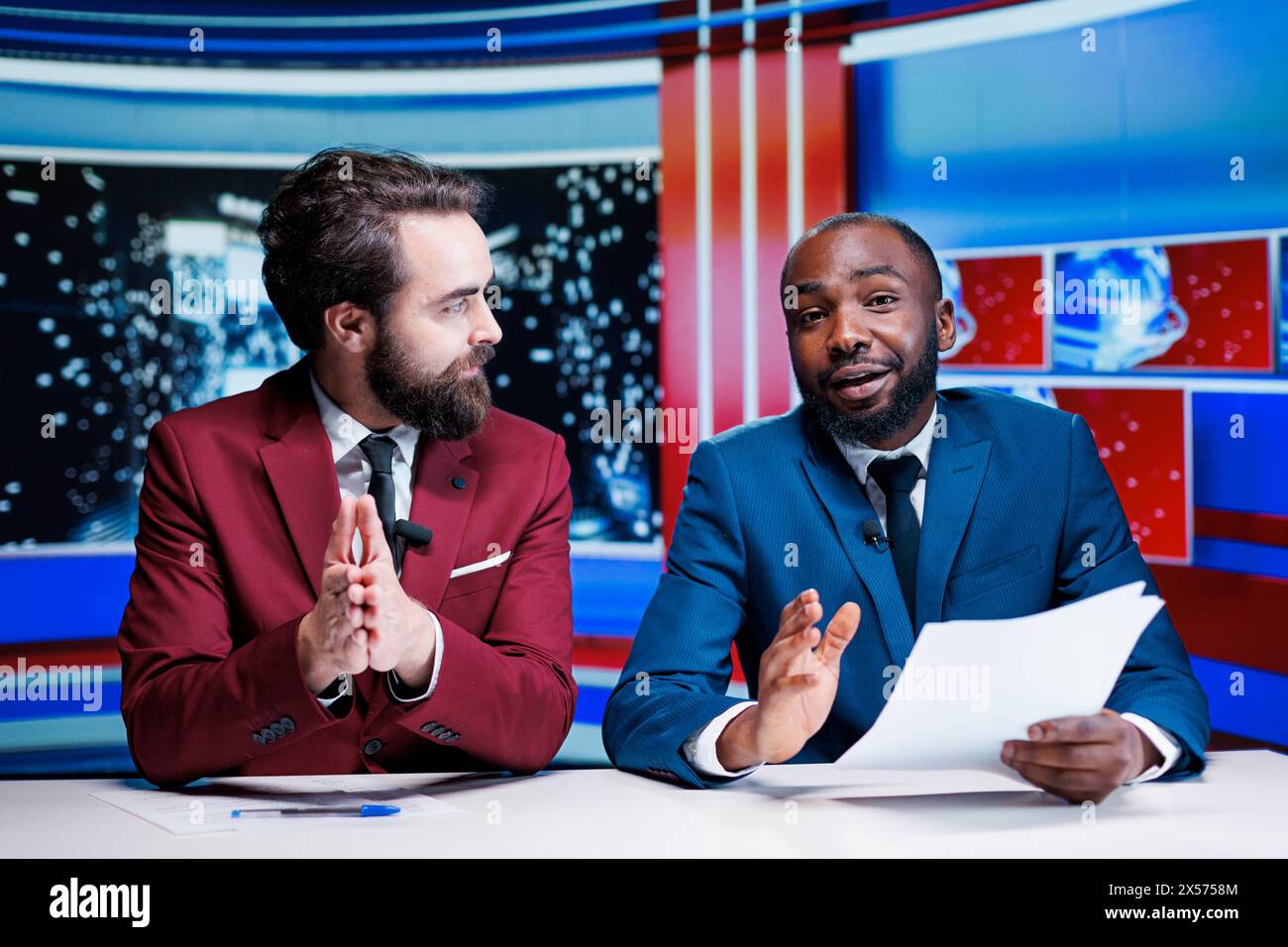 Reporters team presenting news segment in television studio to host ...