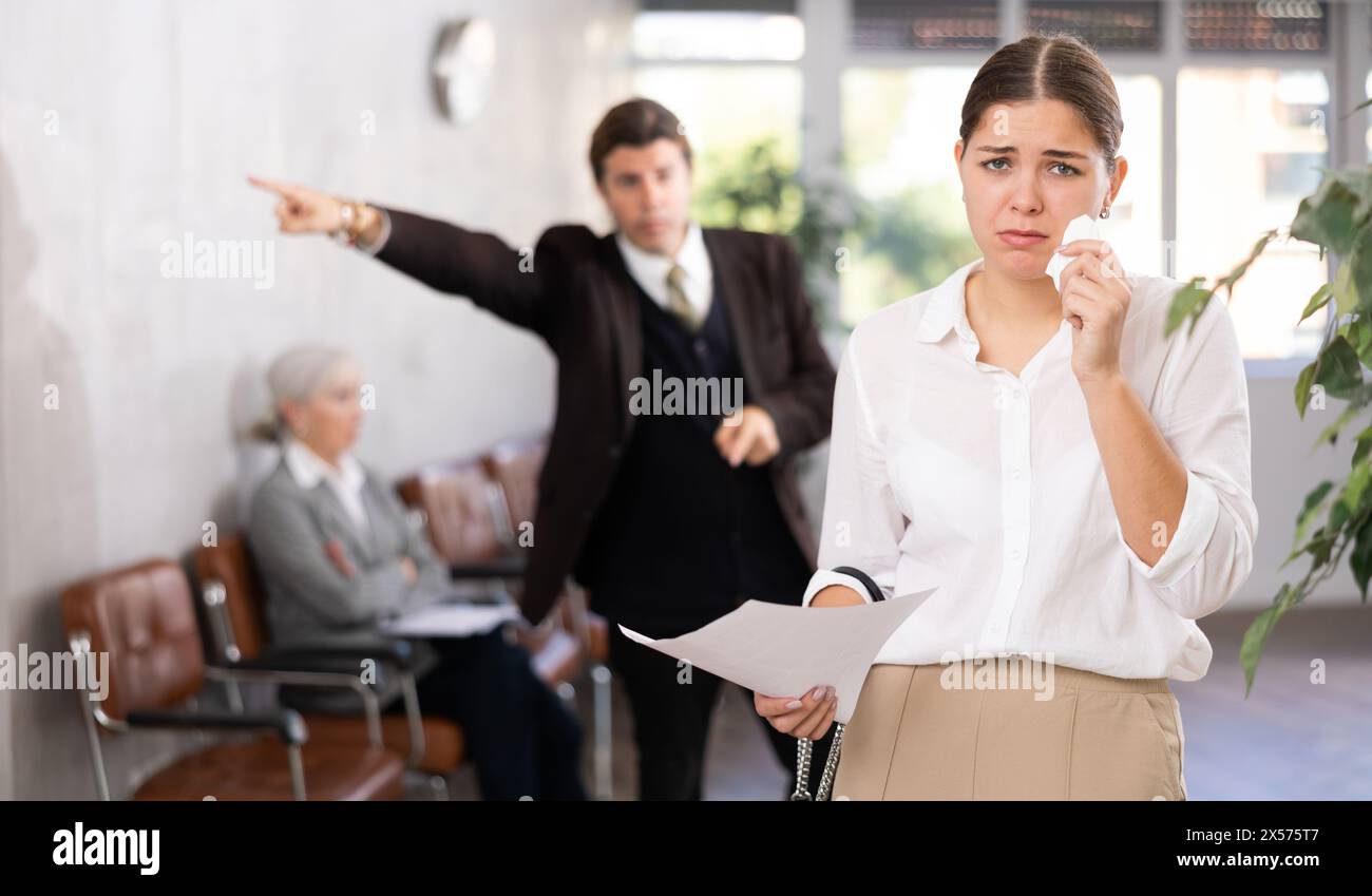 Upset young businesswoman with disgruntled boss pointing at door Stock ...