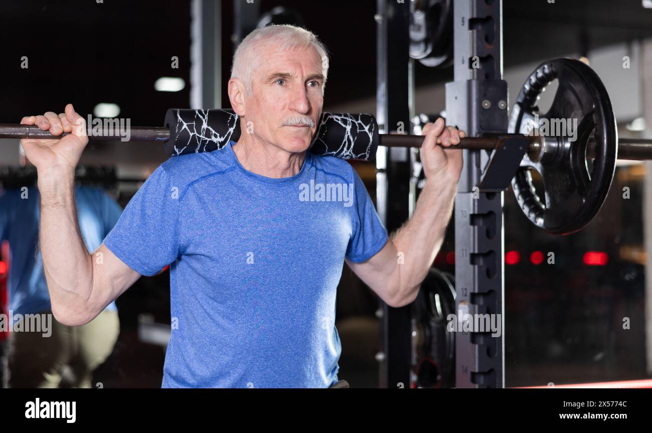 Active man during exercises to strengthen muscles of hands and body ...