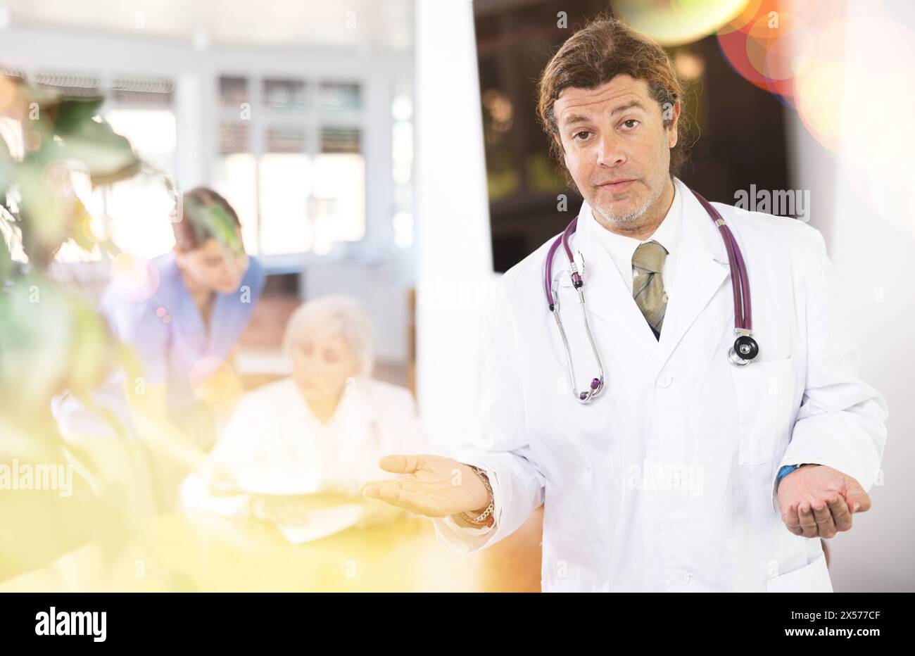 Friendly doctor invites you to visit clinic for diagnosis Stock Photo ...