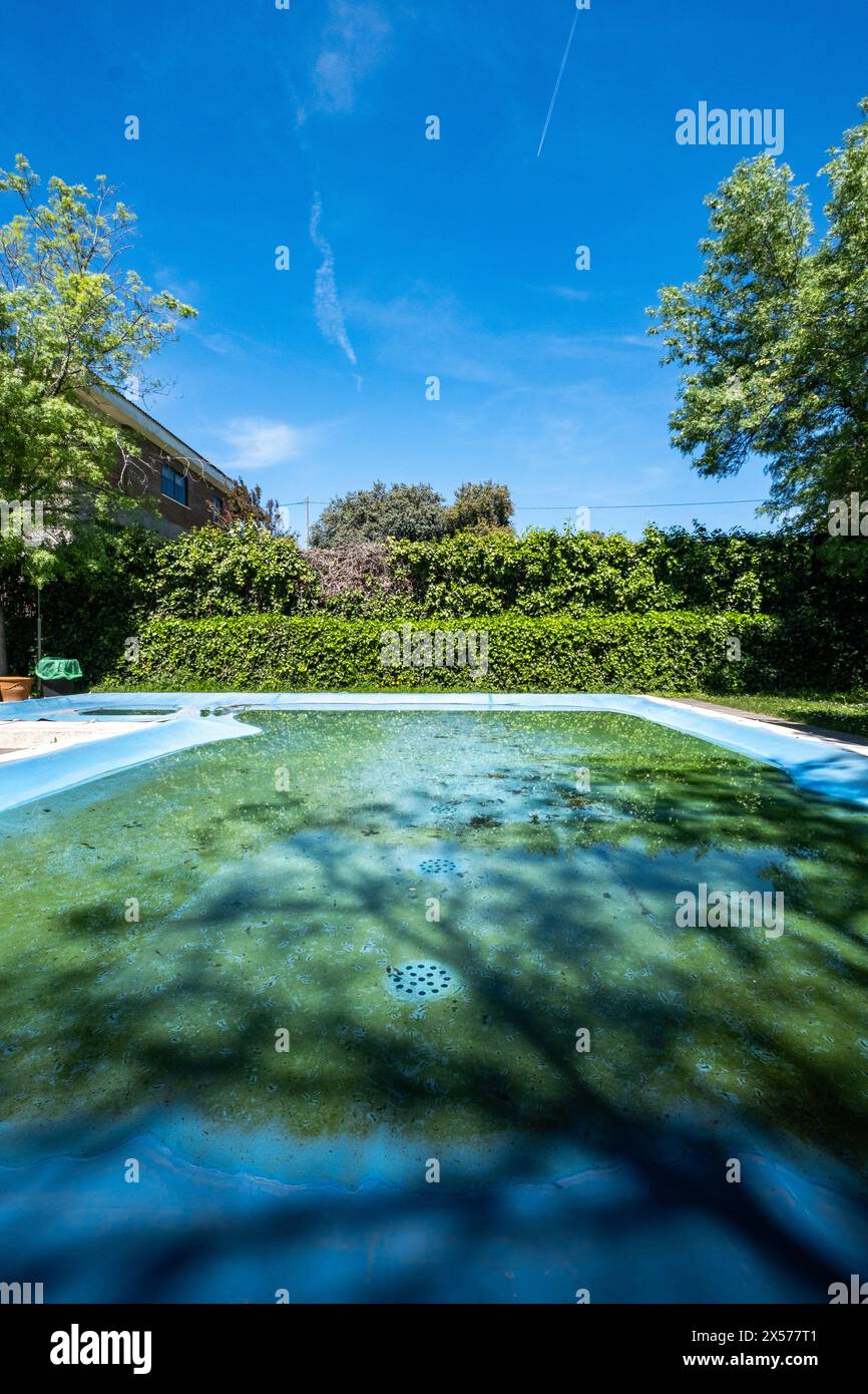 A swimming pool of a villa has been covered for the winter and has ...