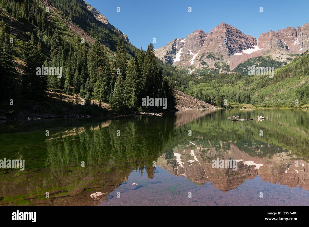 A still morning reflection of the Maroon Bells that are located in the ...