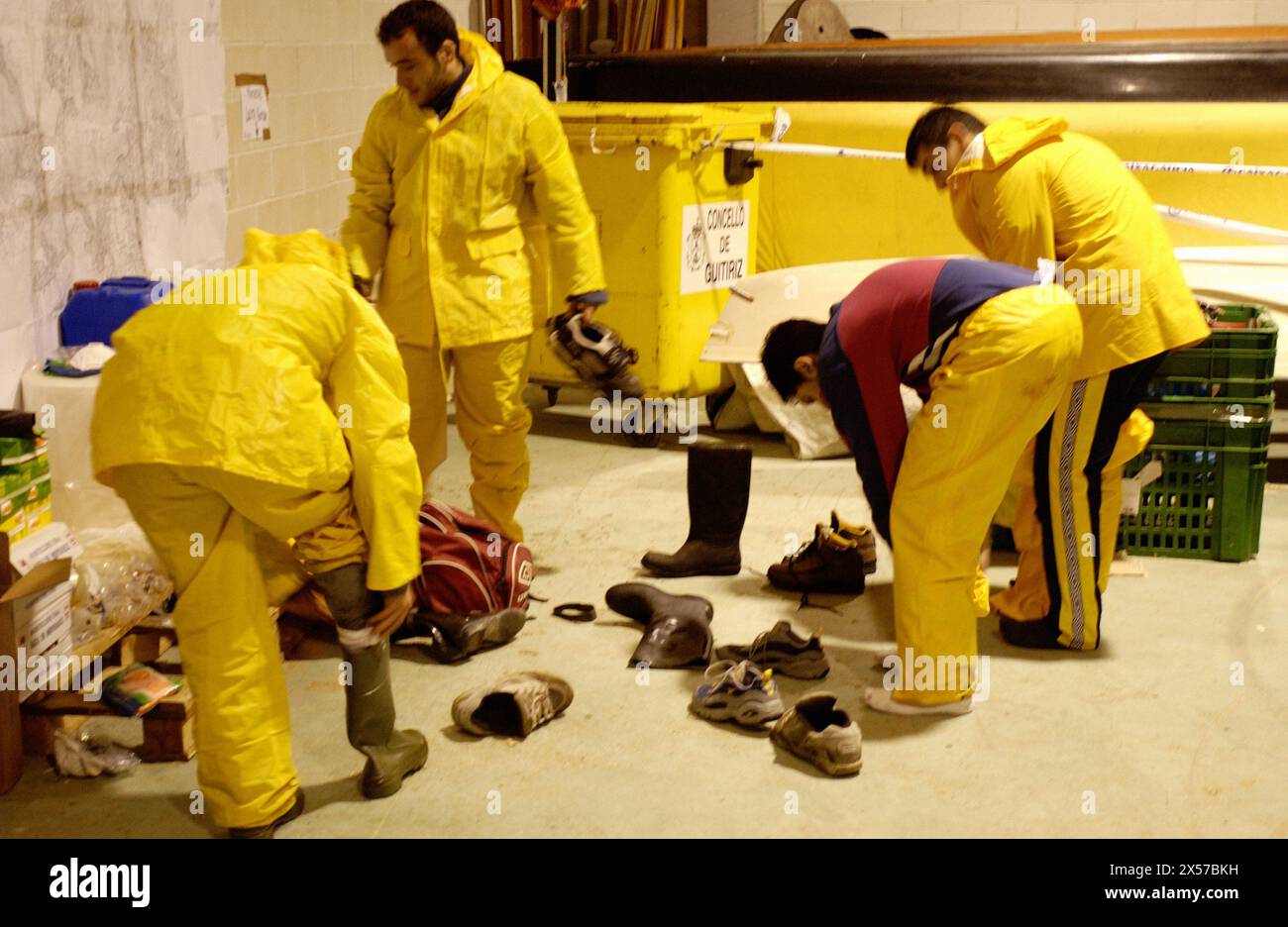 Volunteers dressing protective clothing before going to gather the fuel ...