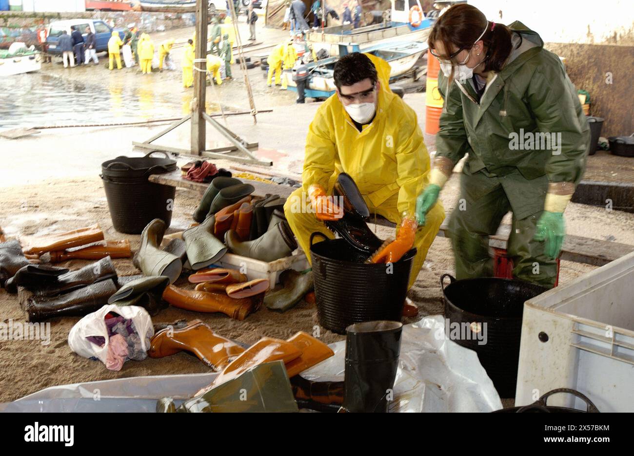 Volunteers dressing protective clothing before going to gather the fuel ...