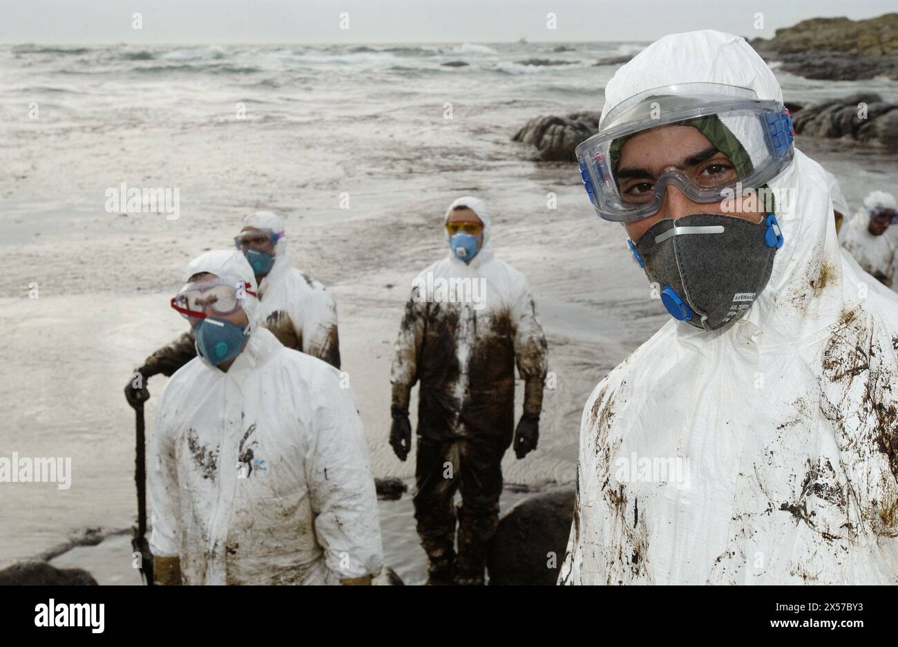 Soldiers dressed with protective clothing cleaning up the oil spill ...