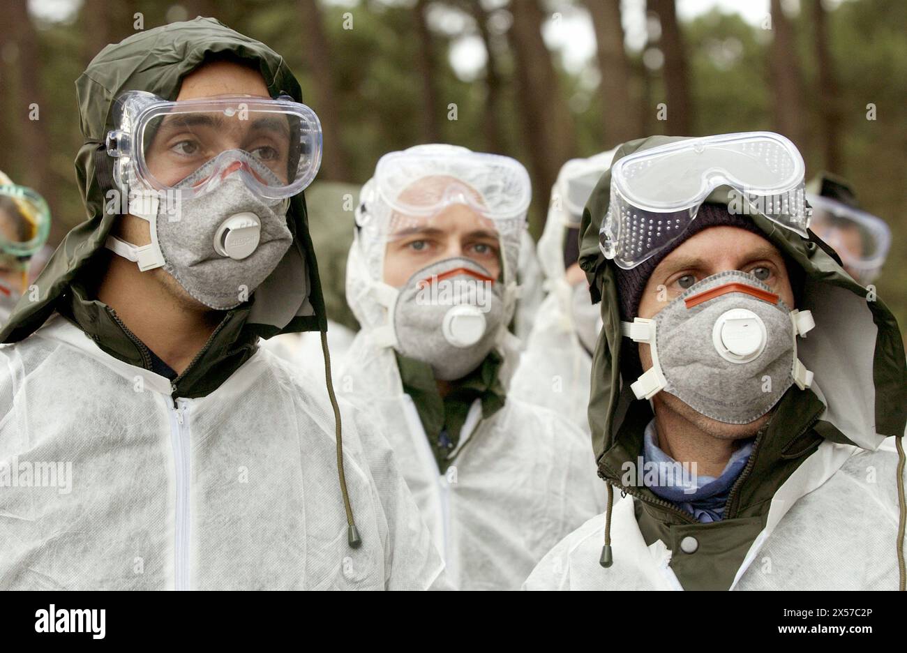 Volunteers dressed with protective clothing to gather the fuel spill ...