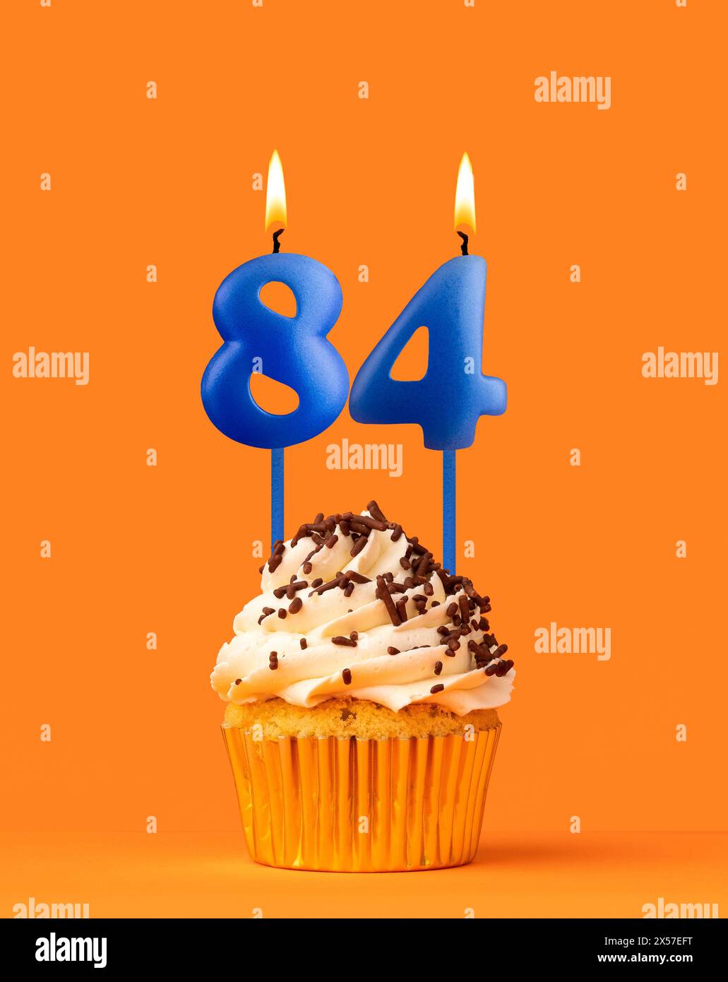 Blue birthday candle and cupcake - Number 84 Stock Photo - Alamy