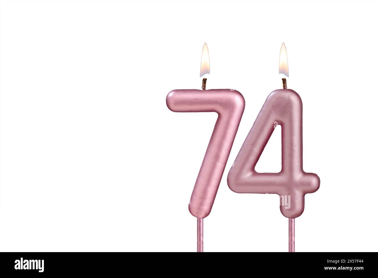 Lit birthday candle - Candle number 74 on white background Stock Photo ...