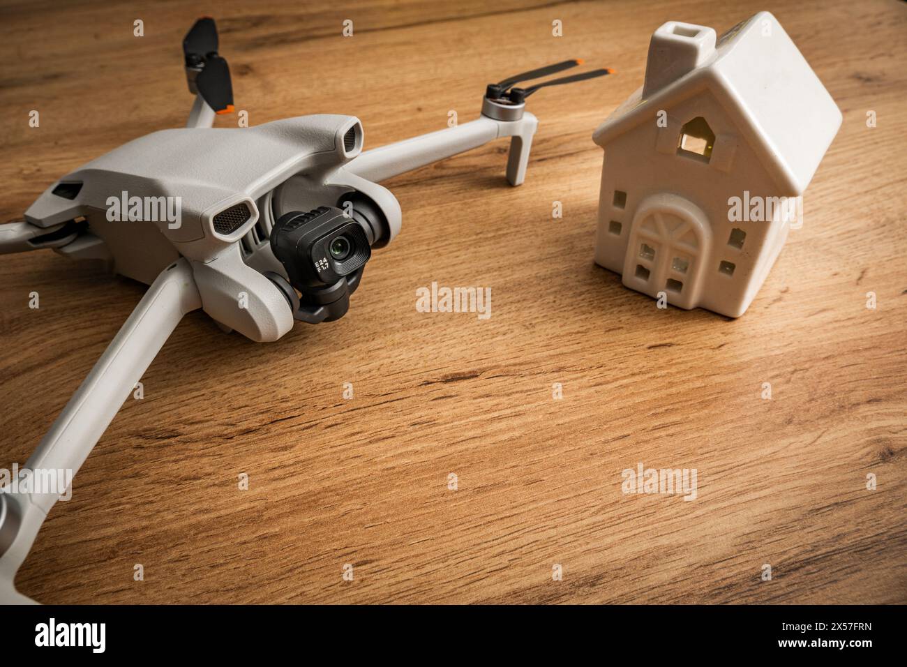 Drone camera next to a ceramic model house ones privacy UAV surveillance, home security ...