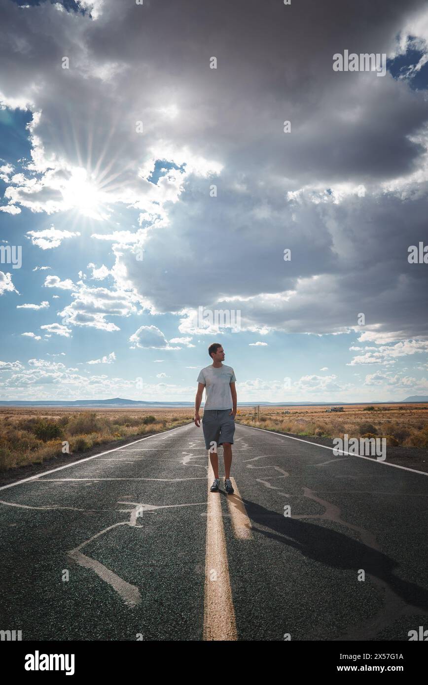 Person Standing on Dividing Line of Two Lane Road, Arizona Stock Photo ...
