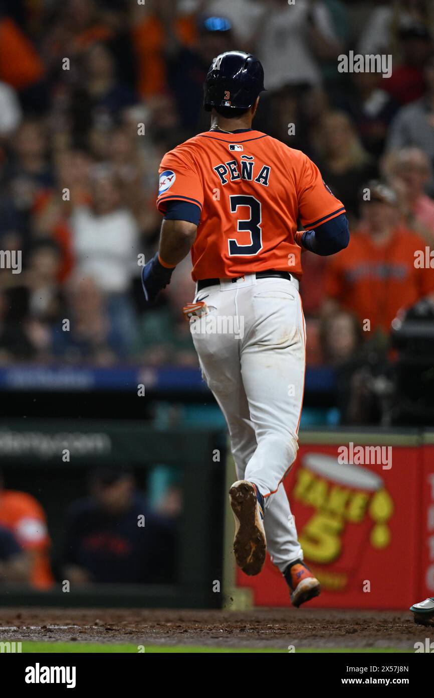 Houston Astros shortstop Jeremy Pe–a (3) scores on a throwing error ...