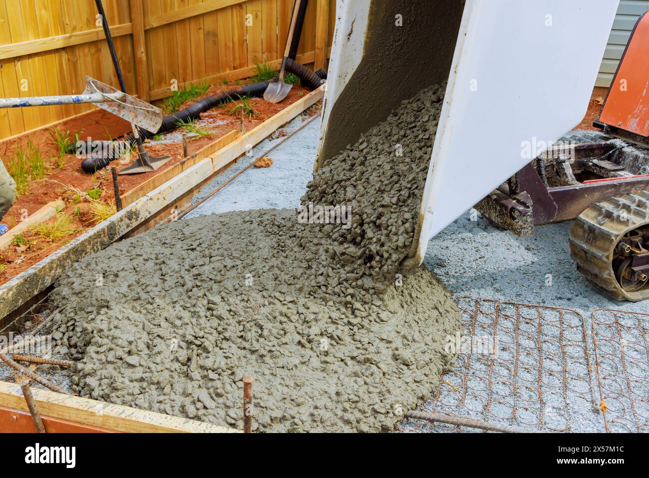 In course construction of foundation, wet cement is poured into ...
