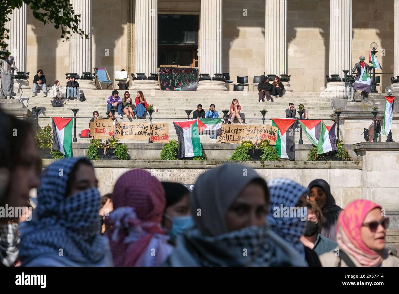 London, UK. Placards placed on the steps of UCL's Wilkins Buiding after ...