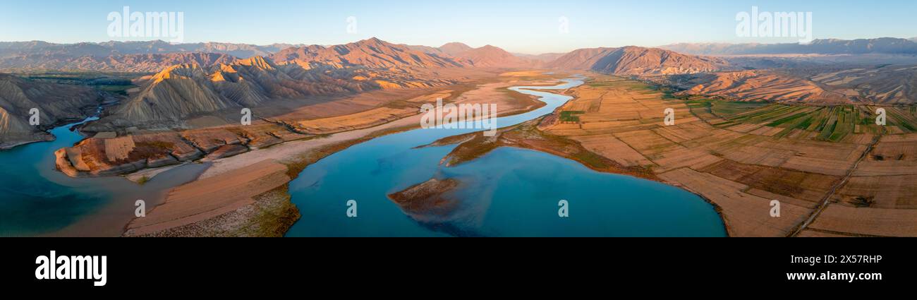Naryn River between mountains and fields, at Toktogul Reservoir at ...