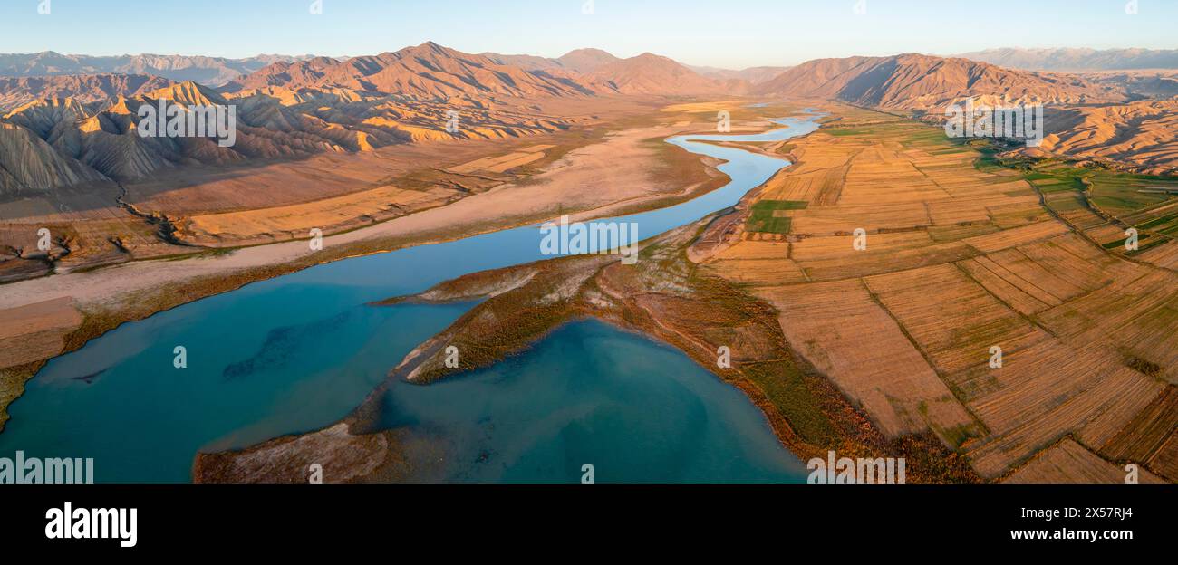 Naryn River between mountains and fields, at Toktogul Reservoir at ...