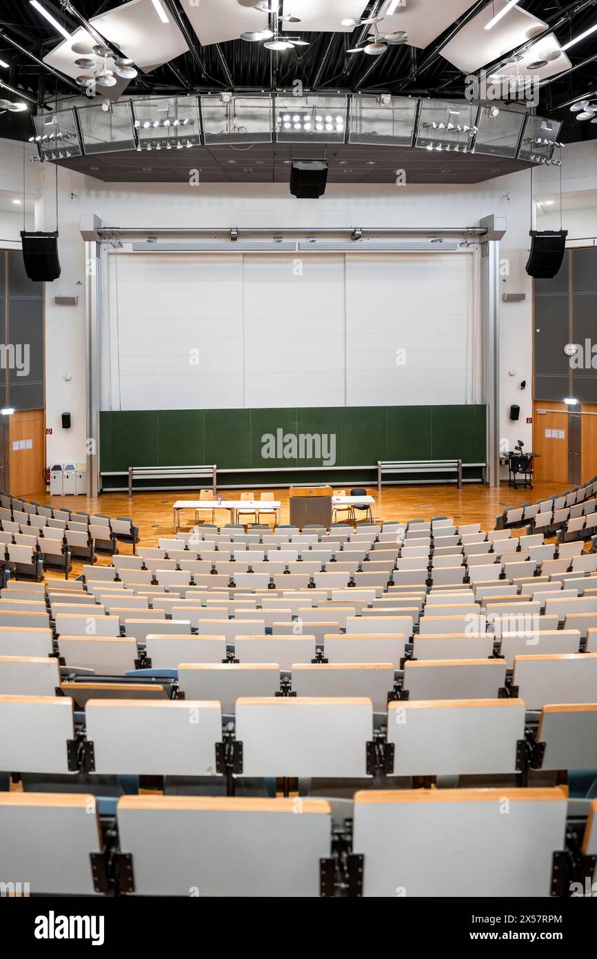View from the rows of seats into an empty lecture theatre, interior ...