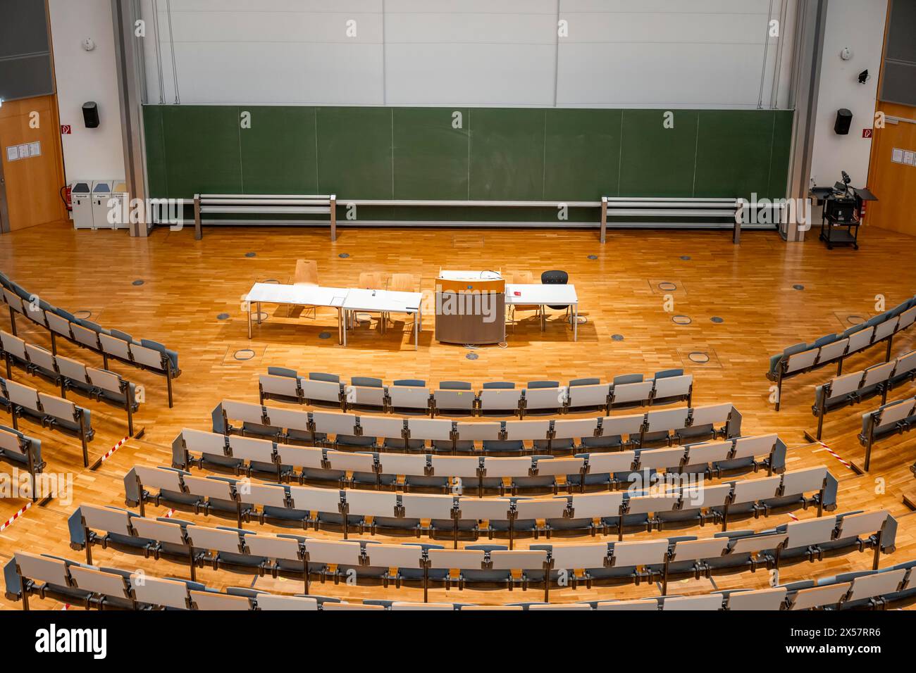View from above into an empty lecture theatre with rows of seats and ...