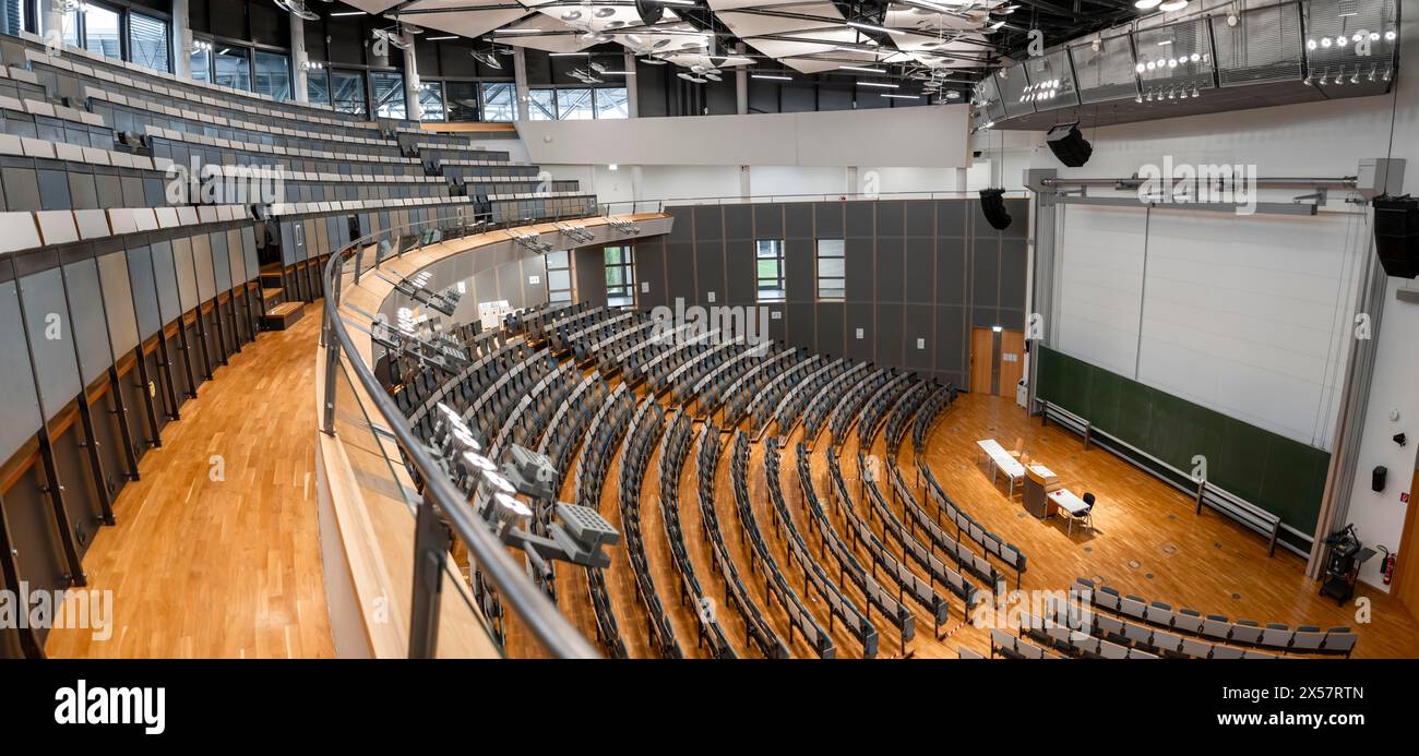 View from the gallery into an empty lecture theatre with rows of seats ...