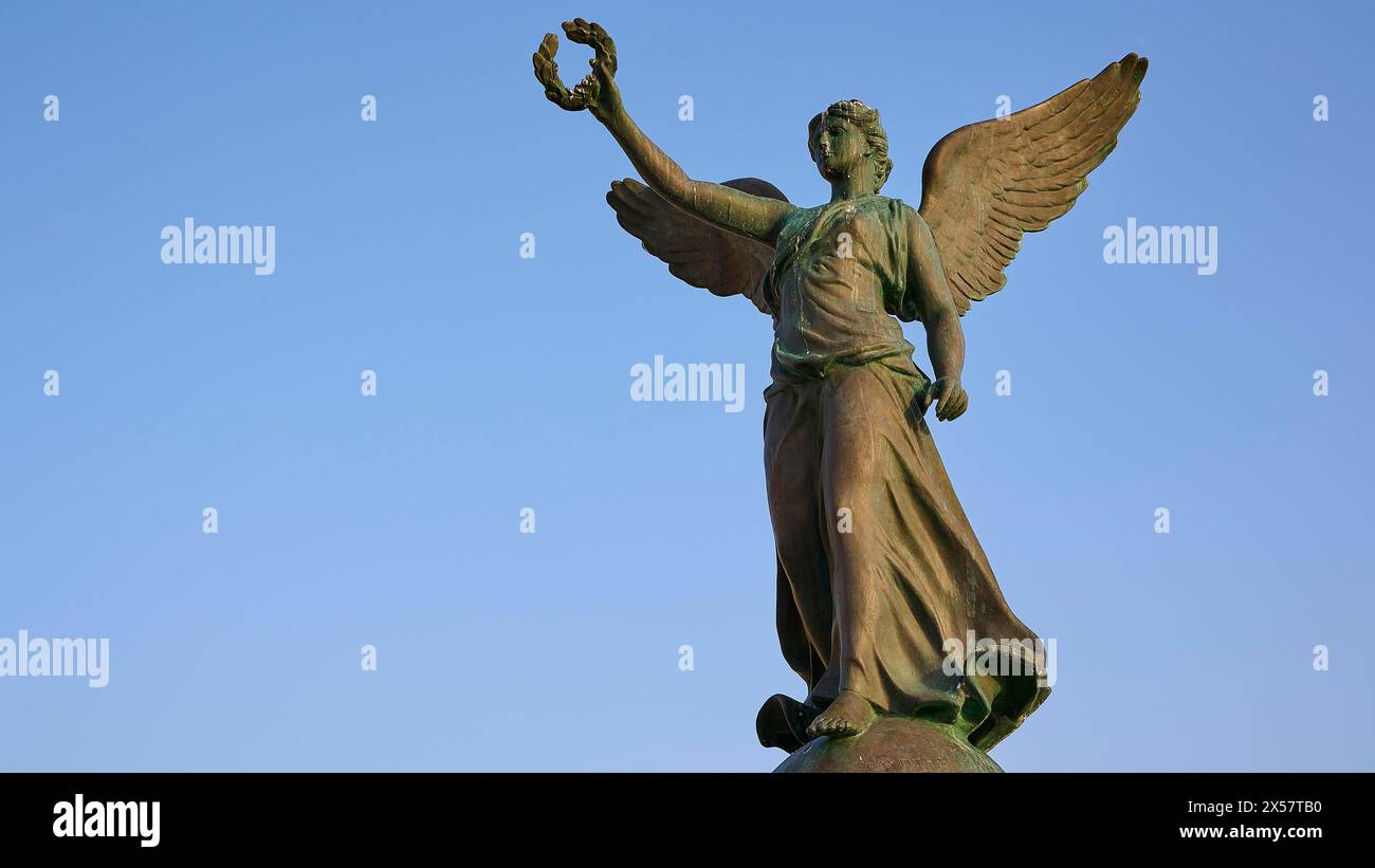 Angel statue with raised hand and outstretched wings towards the sky ...
