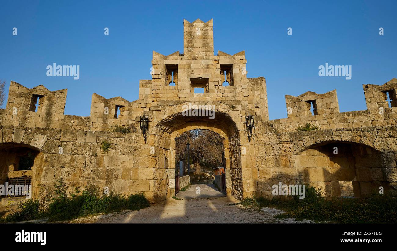 Ancient stone gate of a ruin with clear blue sky in the background, Tor ...