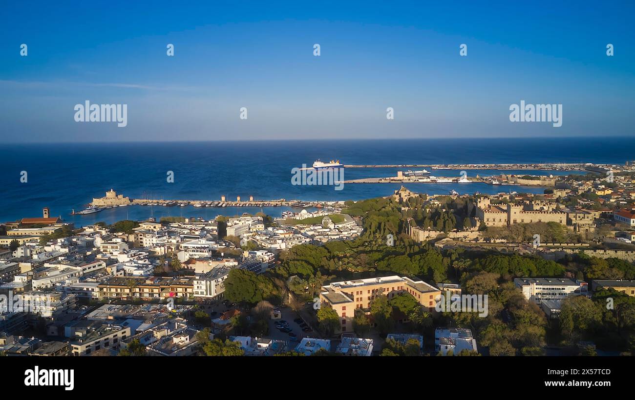 Drone shot, wide view of a coastal town with cruise ships on the sea ...