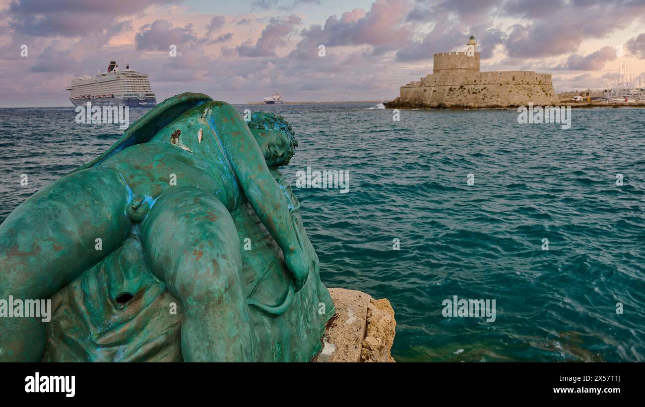 A damaged sculpture looks out over the sea and a fortress during a ...