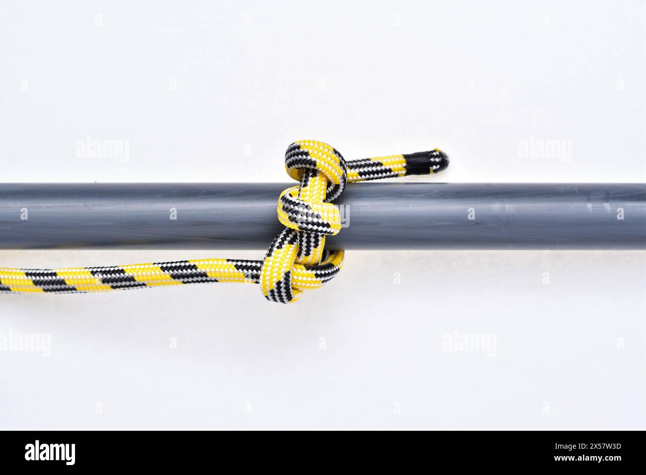 Timber Hitch knot on yellow and black nylon rope on white background ...