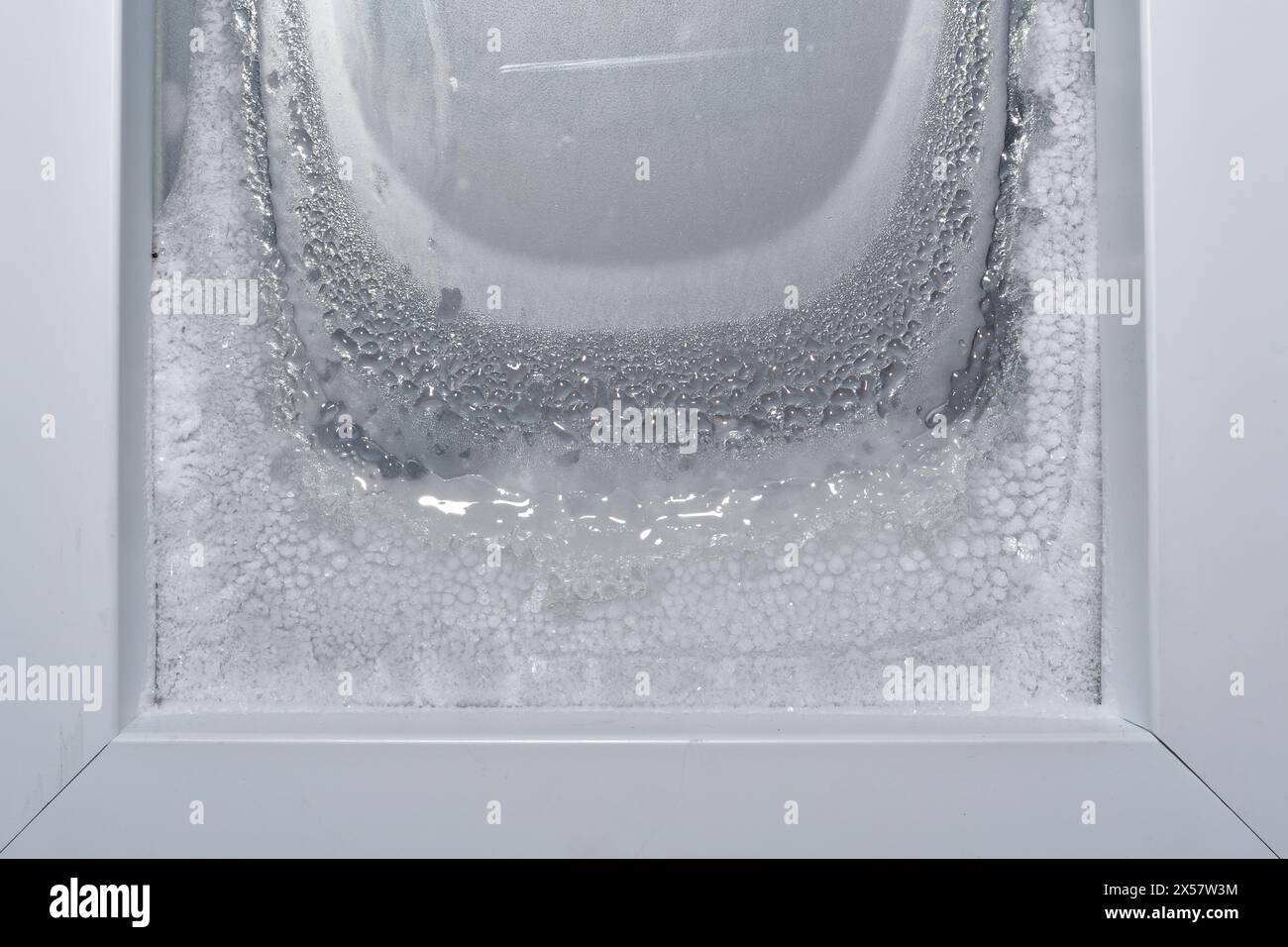 Window heat loss during winter. Frost on window sill due to cold winter ...