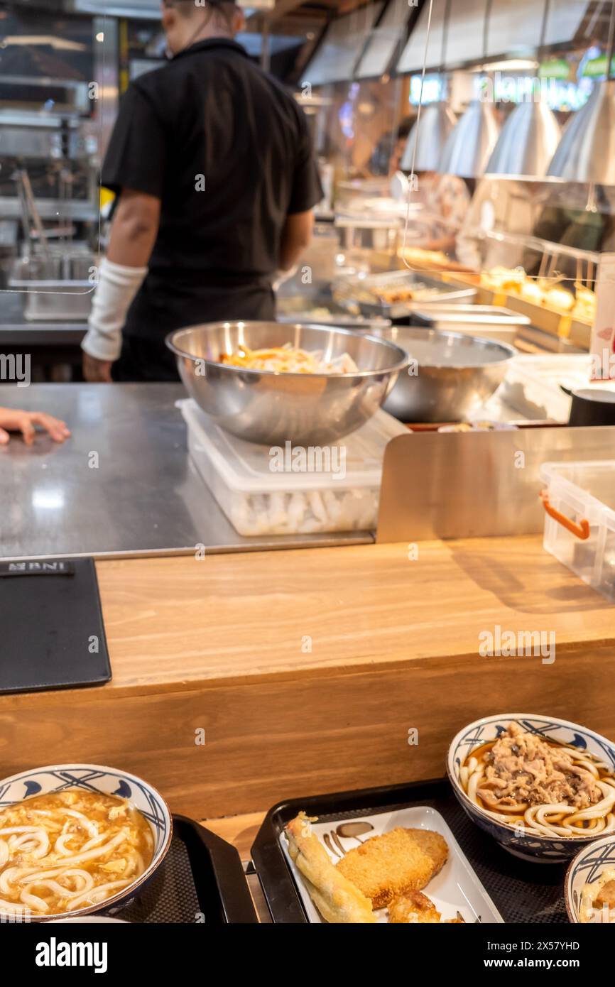 Noodles menu at Japanese restaurant with chef cooking on the background ...