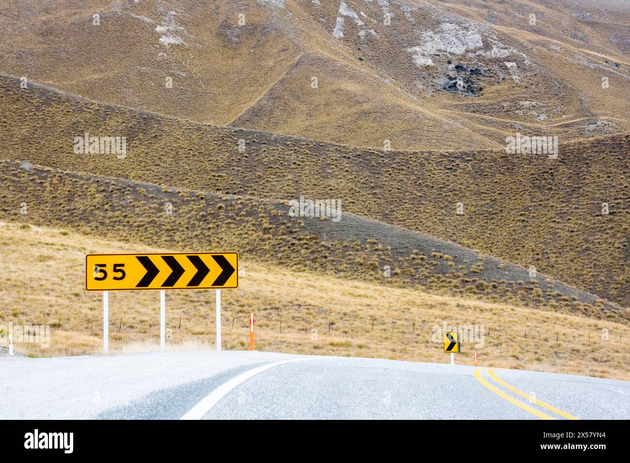 Road through Lindis Pass Alpine Highway, New Zealand - speed sign of ...