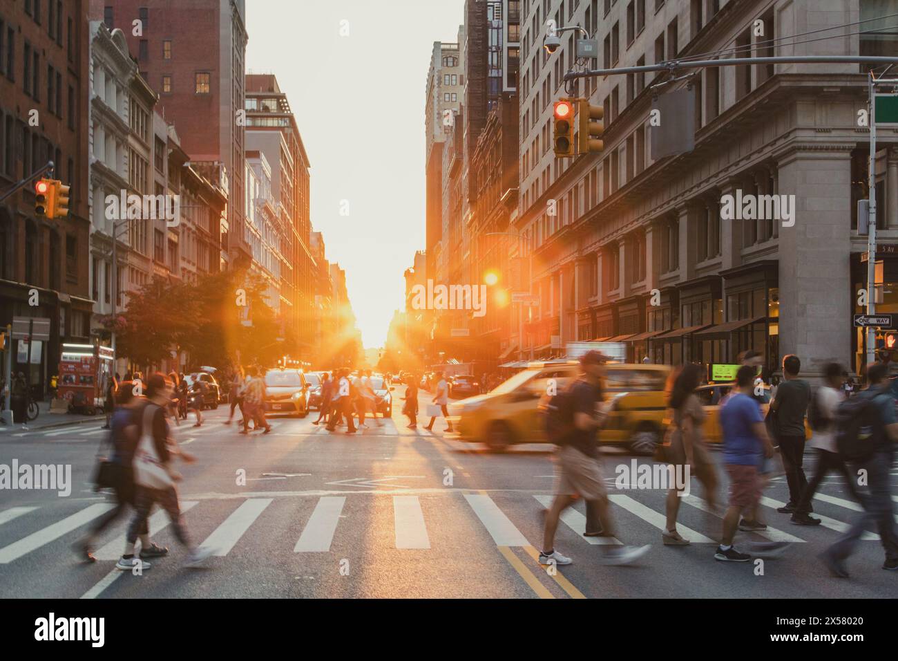 Busy intersection is crowded with people and cars on 5th Avenue and ...