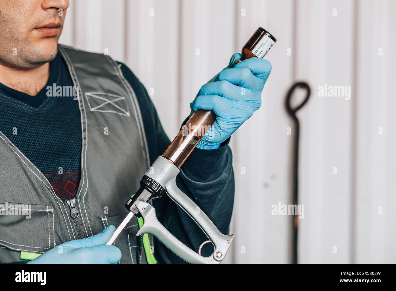 Technician, equipped with a sophisticated syringe, demonstrates field ...