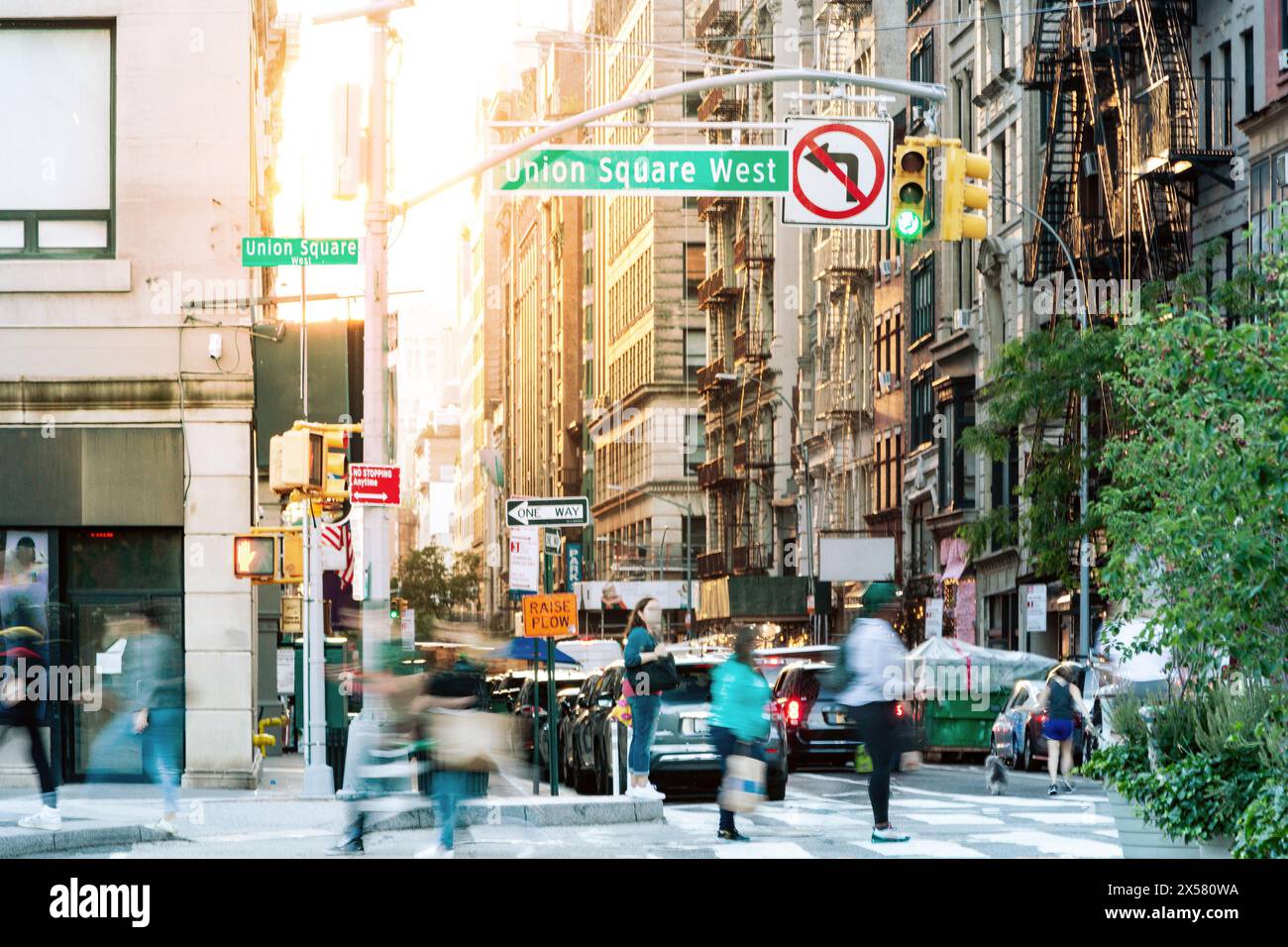 Crowds of people crossing a busy street corner at Union Square Park in ...