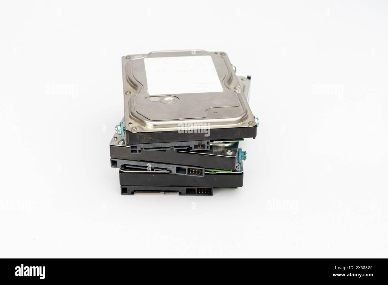 A pile of 3.5 inch computer internal hard disk drives isolated on white ...