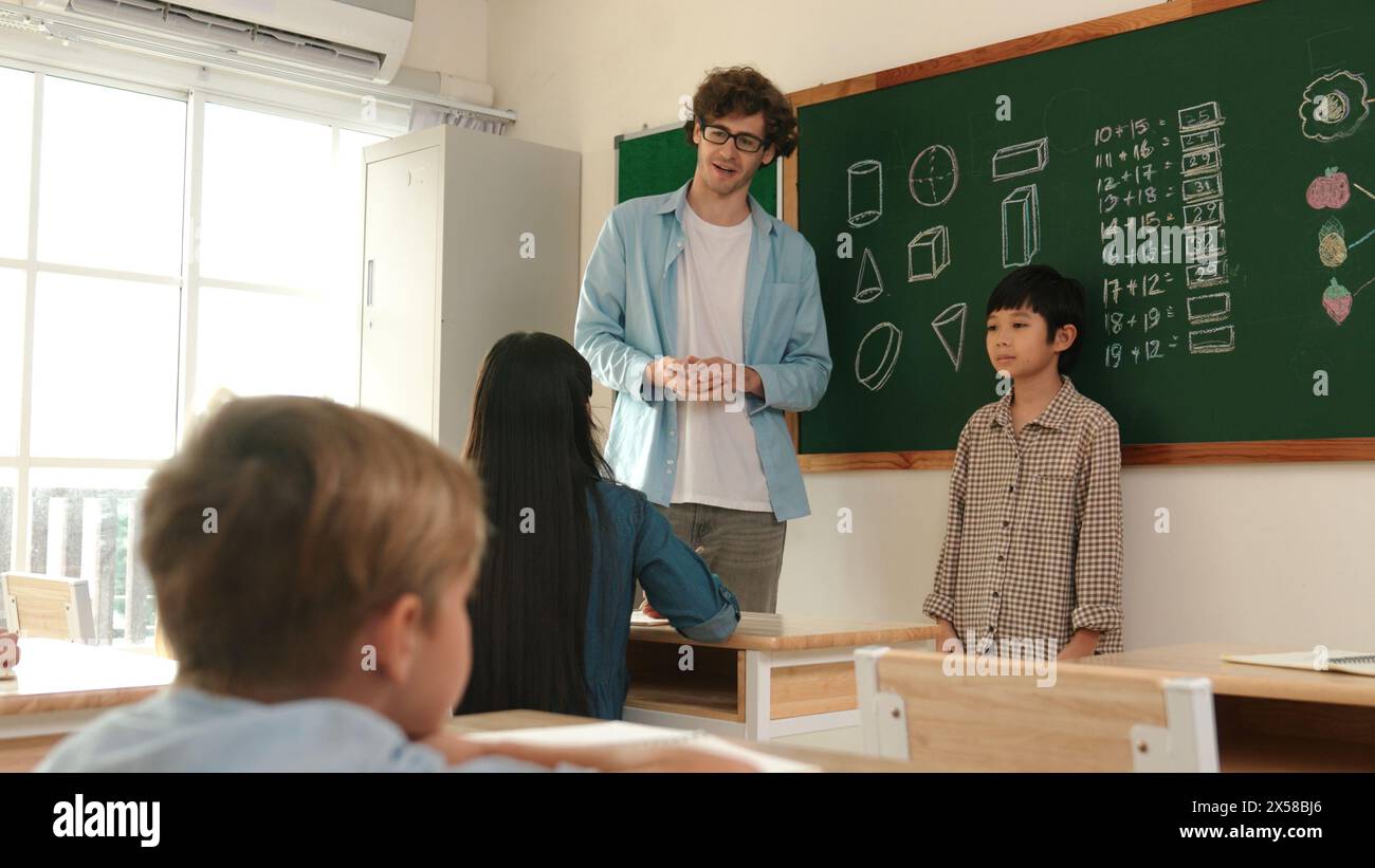 Student standing at in front of class and start to introduce himself at ...