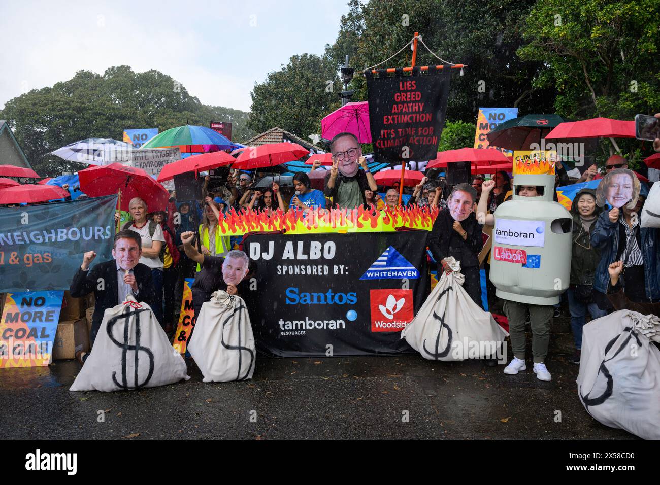 Protesters seen holding bags with dollar signs and wearing masks of ...