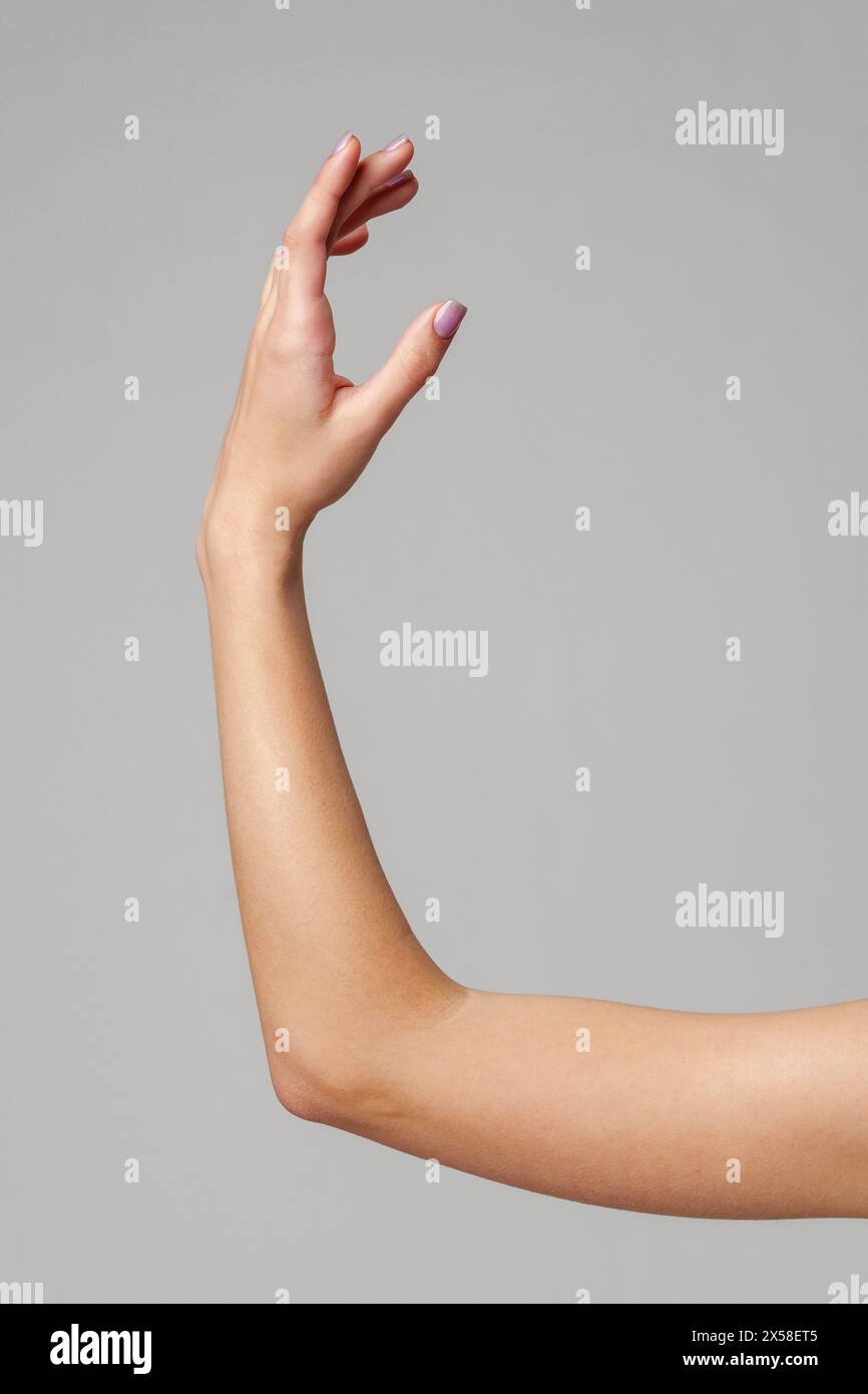 Female hand sign against gray background in studio Stock Photo - Alamy