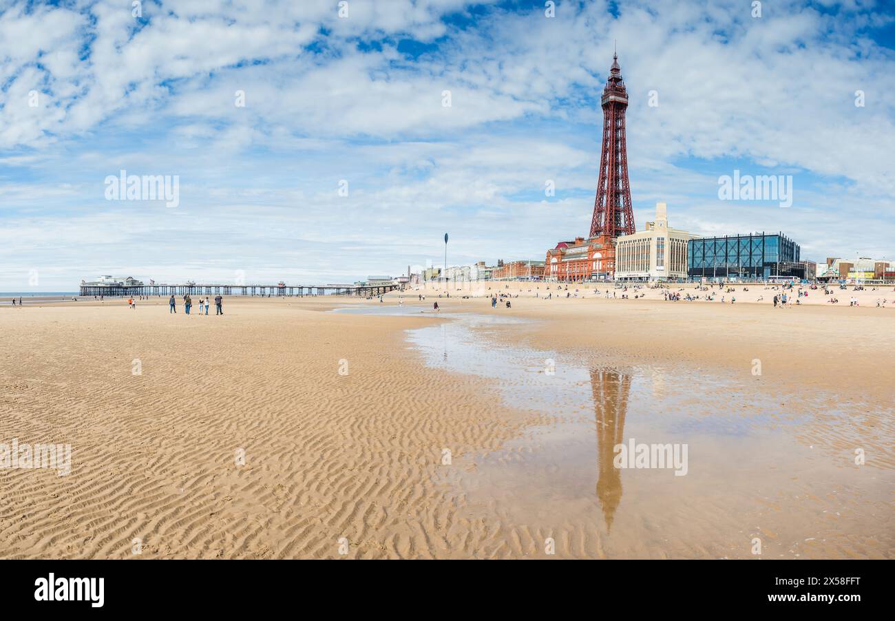 The North Pier next to Blackpool Tower which is seen reflecting in a ...