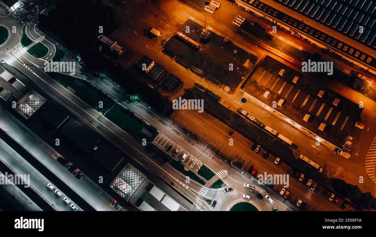 Top view of the bus station and road traffic at night. Car parking top ...